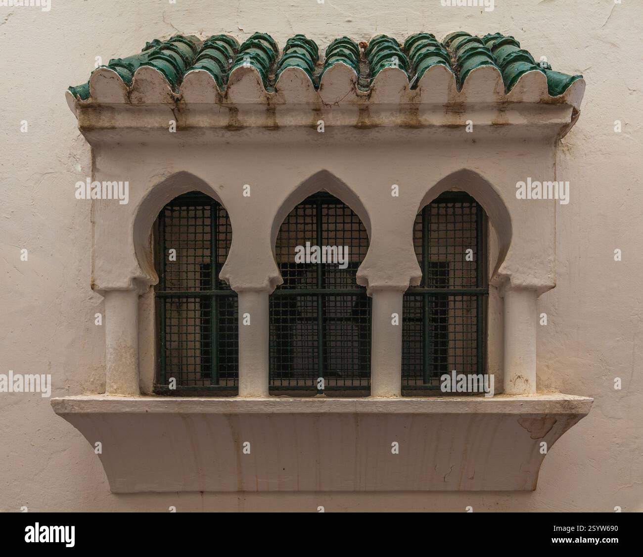 traditional architectural detail with three arched windows framed by a ...