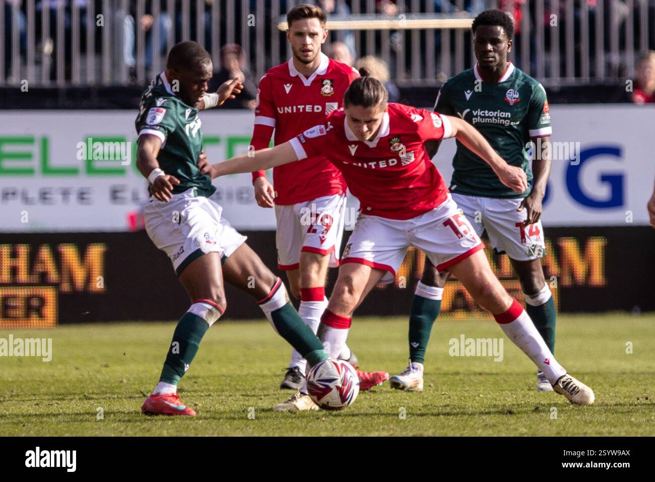 George Dobson of Wrexham AFC fouls Jordi Osei-Tutu of Bolton Wanderers ...