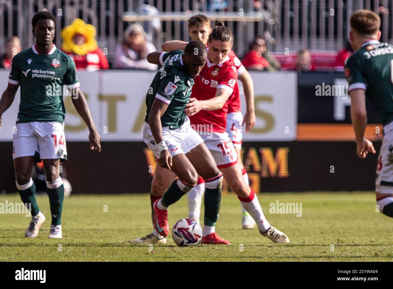 George Dobson of Wrexham AFC fouls Jordi Osei-Tutu of Bolton Wanderers ...