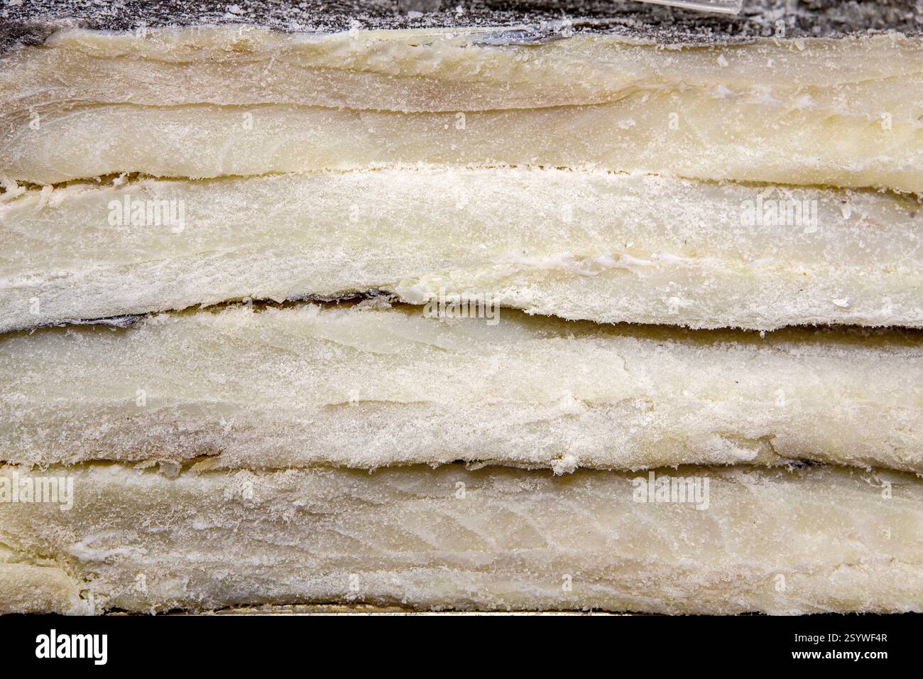 Pile of dried and salted codfish fillets on sale at a market stall ...