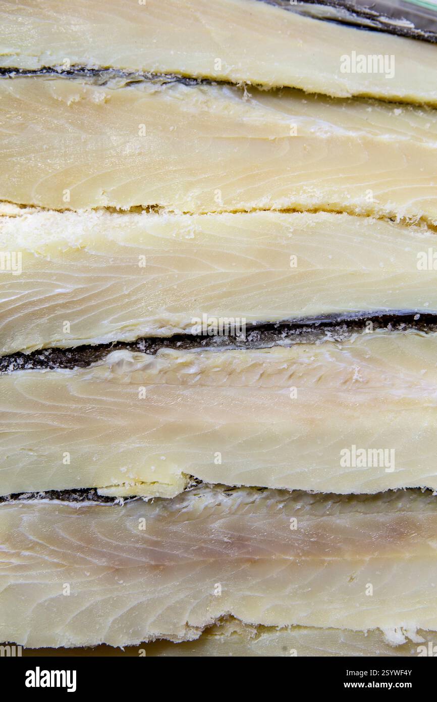 Pile of dried and salted codfish fillets on sale at a market stall ...