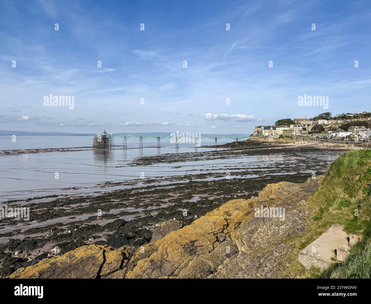 Low tide reveals the iconic Clevedon Pier. People enjoy the beach Stock ...