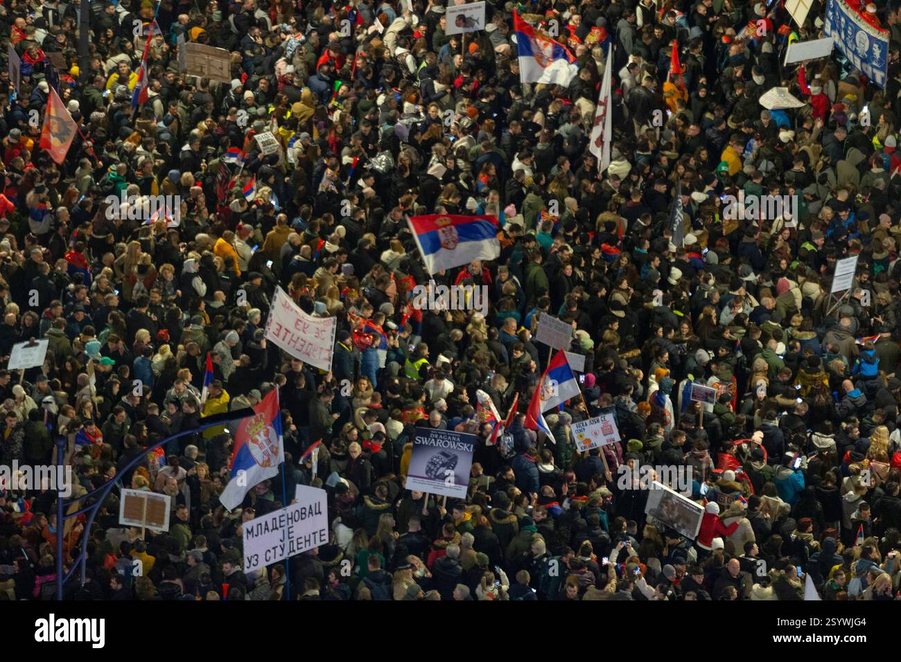 People wave Serbian flags as they gather at a square during a student ...