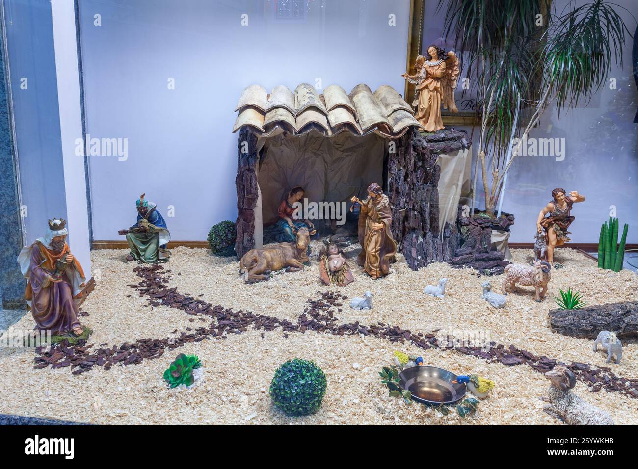 A nativity scene depicting the birth of Jesus with figurines of Mary ...