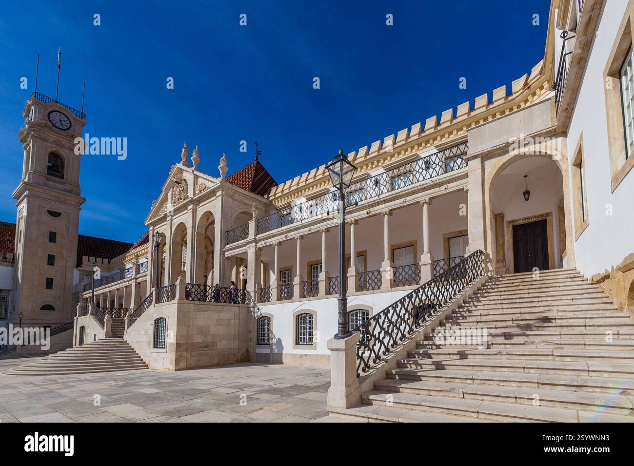 A grand architectural complex featuring a prominent clock tower, ornate ...