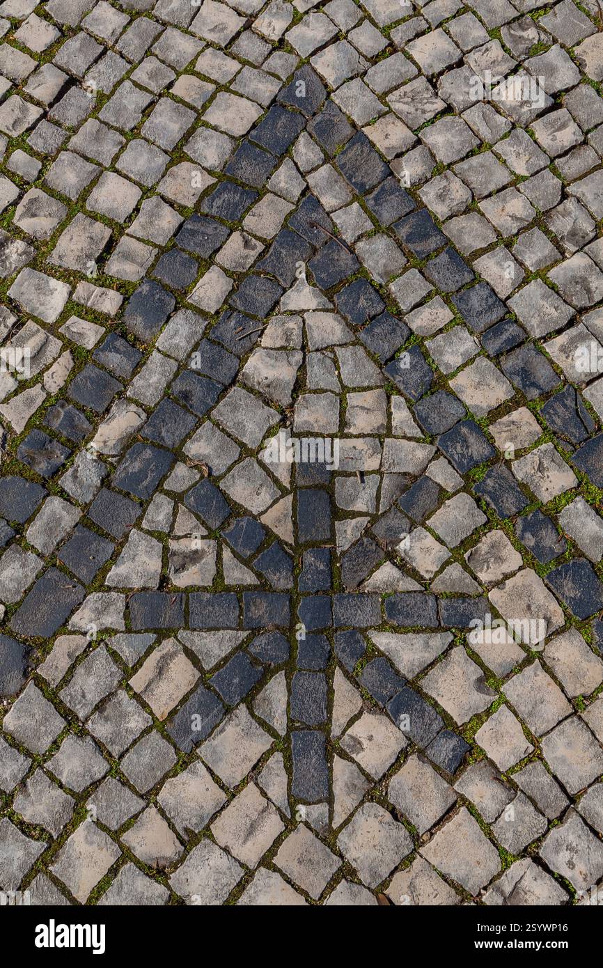 A close-up shot of a cobblestone pavement design featuring a prominent ...