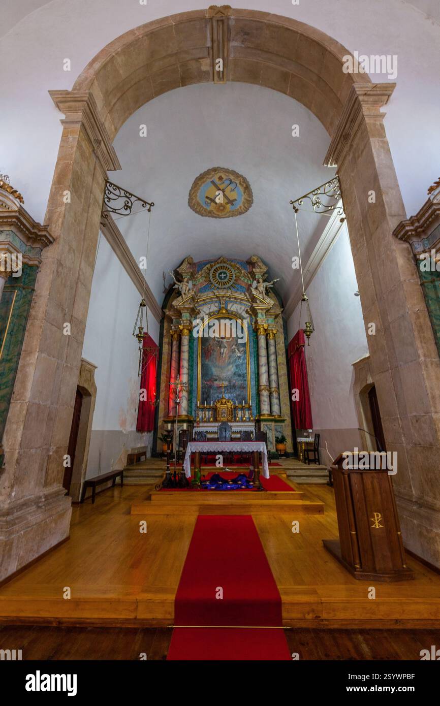 The interior of a religious building showcases an ornate altar with a ...