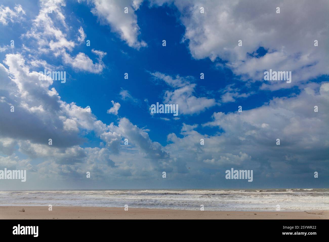 A dynamic sky filled with fluffy white clouds and patches of blue ...