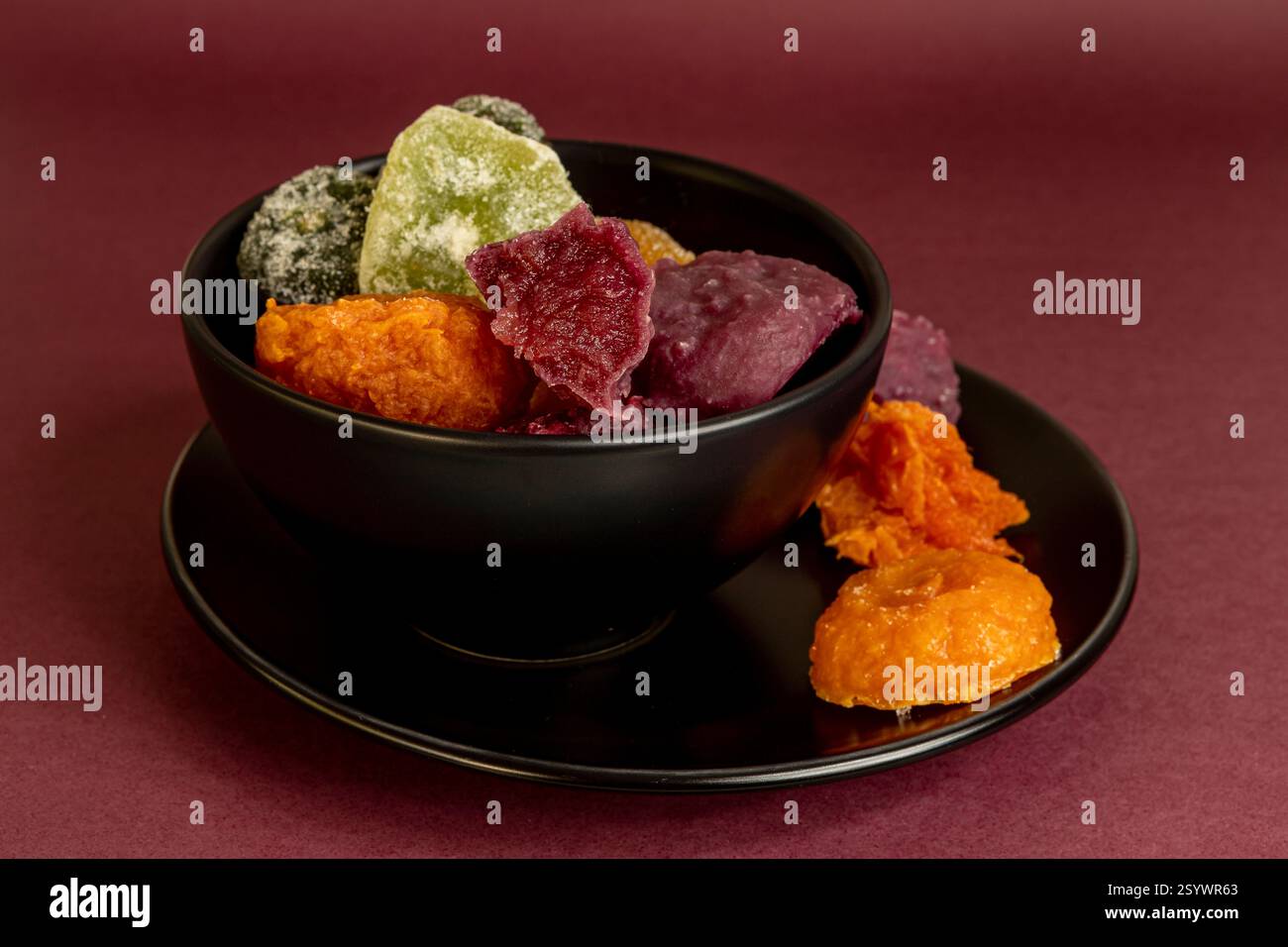 traditional brazilian sweets in bowl on red background. pumpkin jam ...