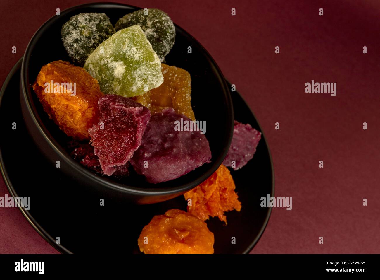 traditional brazilian sweets in bowl on red background. pumpkin jam ...