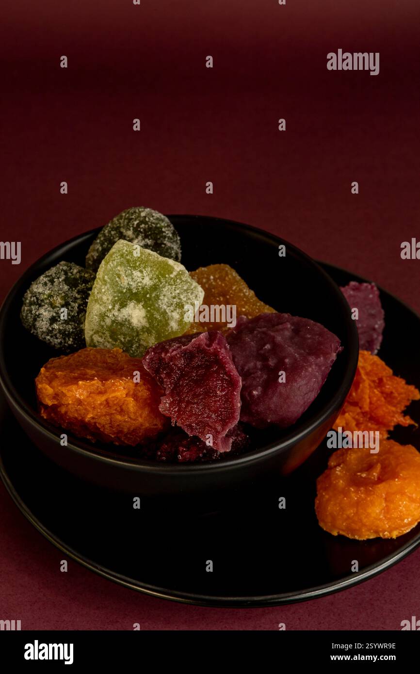 traditional brazilian sweets in bowl on red background. pumpkin jam ...