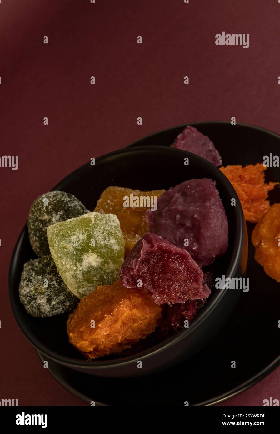traditional brazilian sweets in bowl on red background. pumpkin jam ...