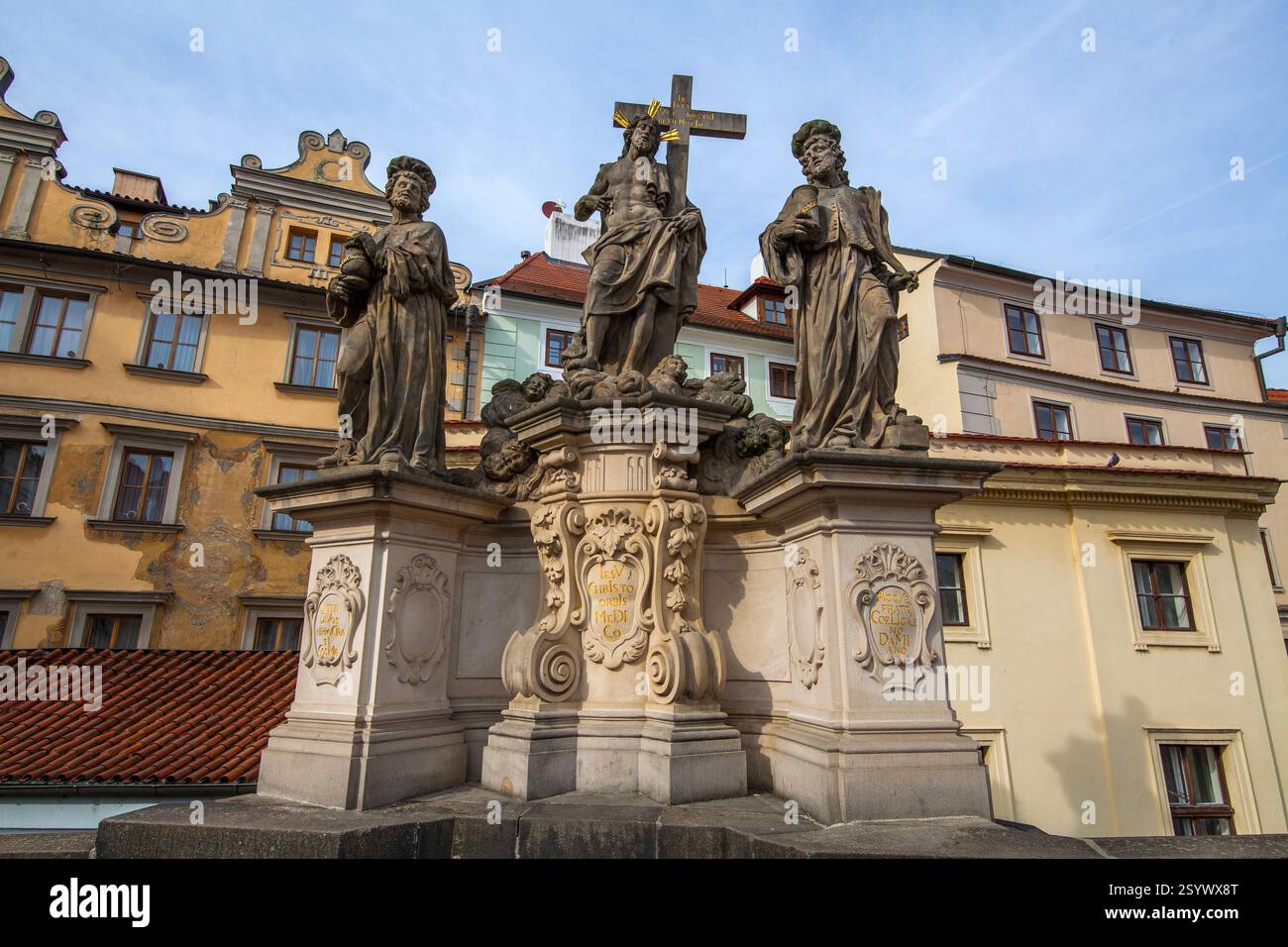 A statue group featuring three figures with detailed clothing ...
