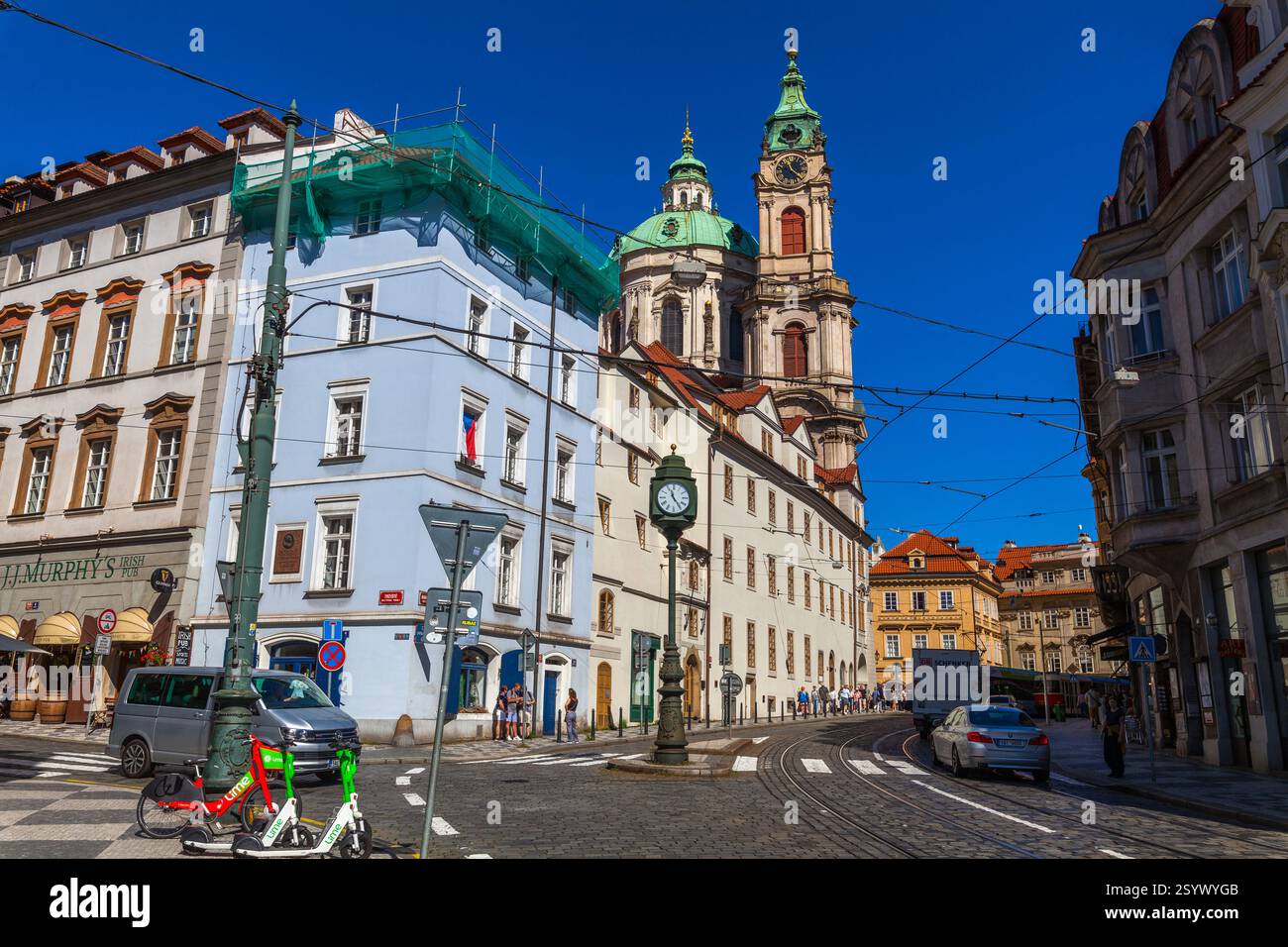 A bustling European city square features a historic church with twin ...