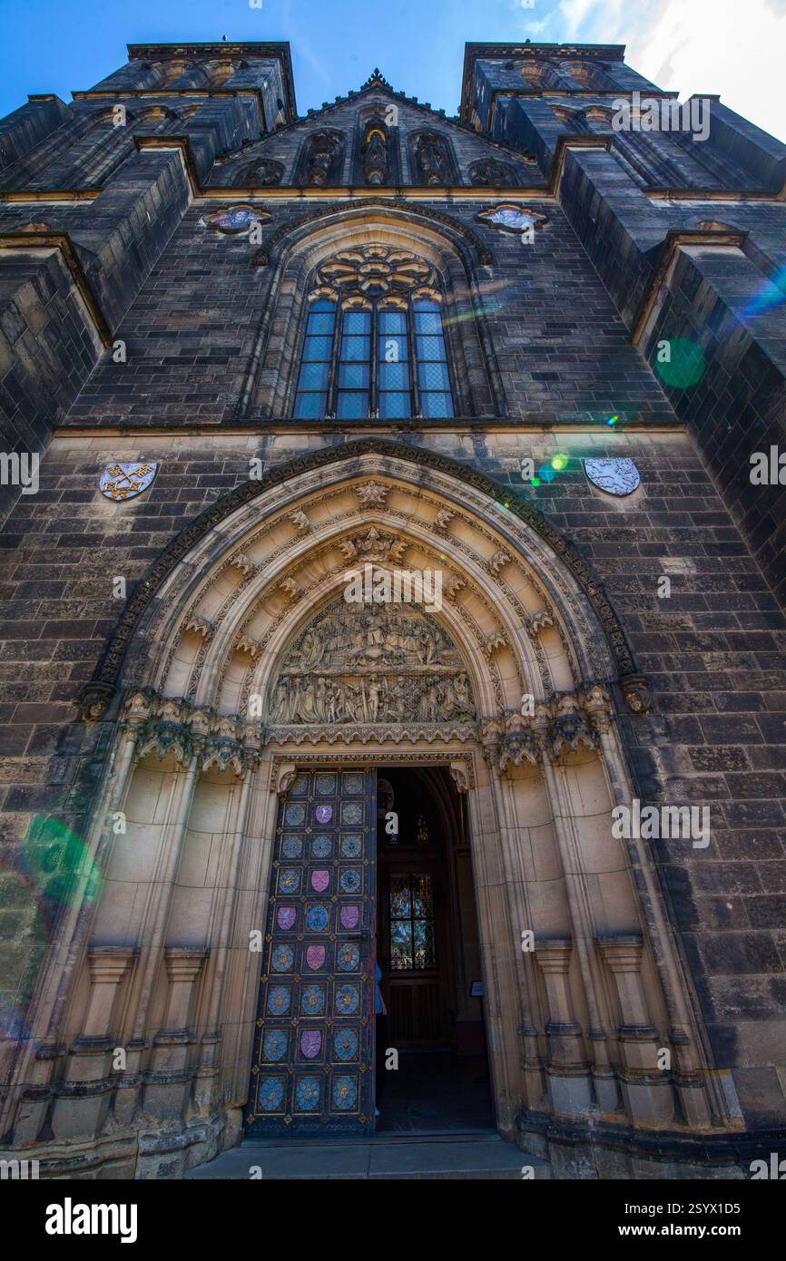 A low-angle view of a grand stone church with twin towers, featuring an ...
