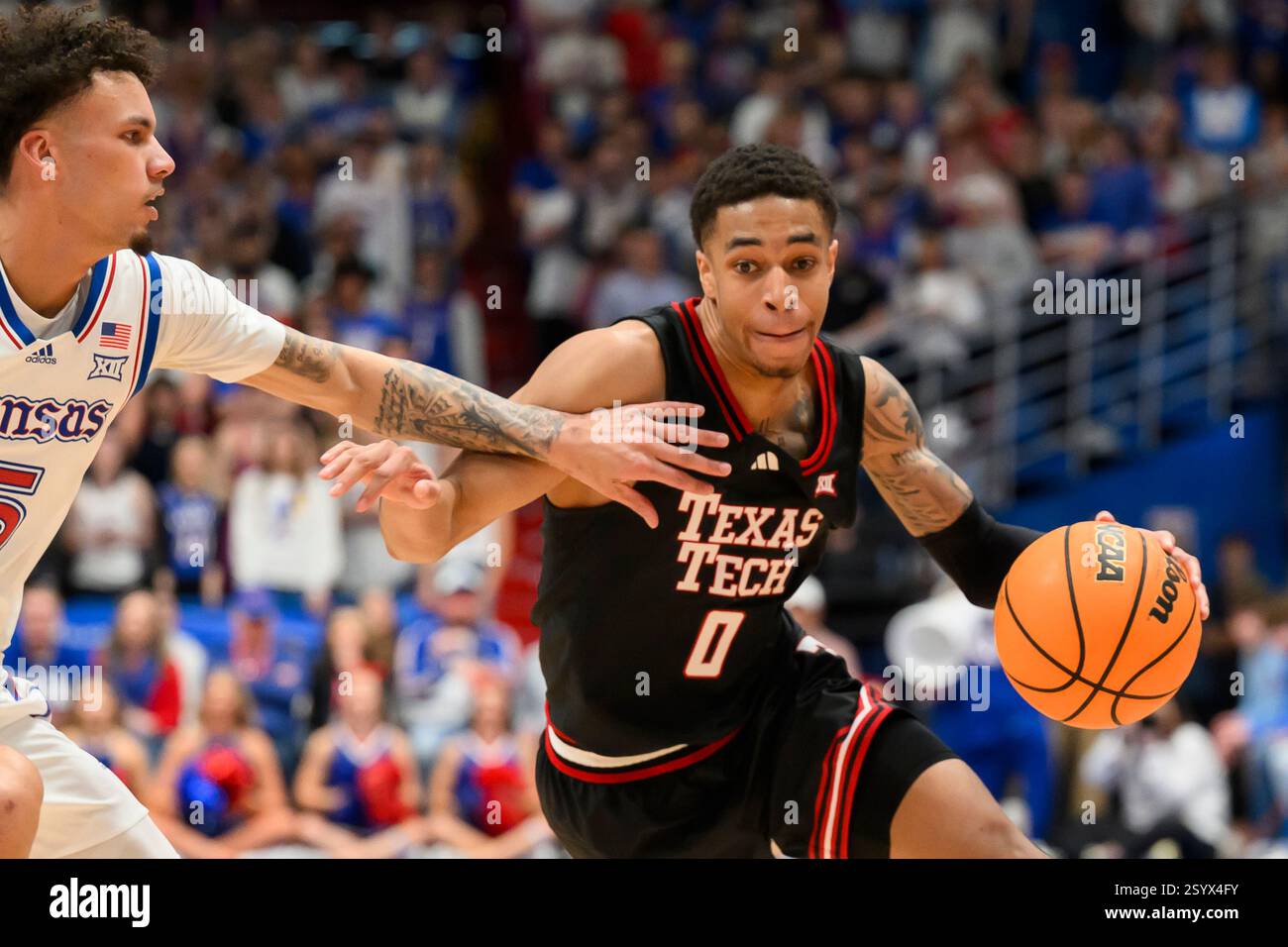 Texas Tech guard Chance McMillian (0) drives against Kansas guard Zeke ...