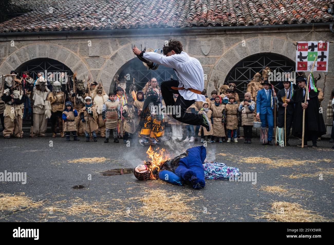 A young man representing “La Vaquilla“ (the heifer) jumps over the two “Peleles“ (Dummy) burning ...