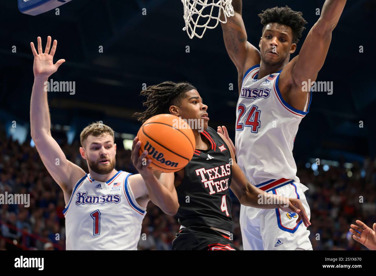 Texas Tech guard Christian Anderson (4) passes from underneath the ...