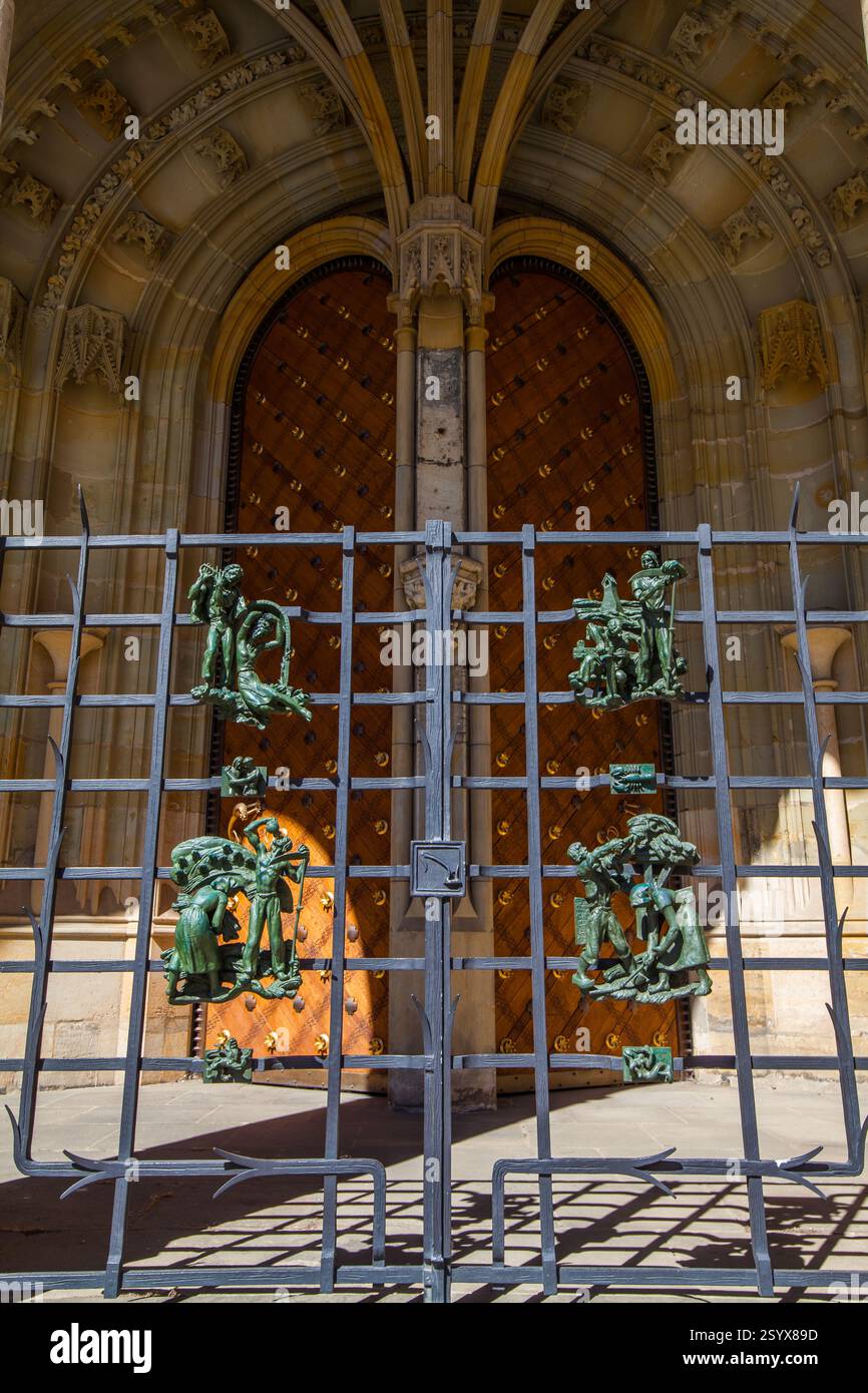 A detailed metal gate with artistic bronze relief sculptures stands in ...