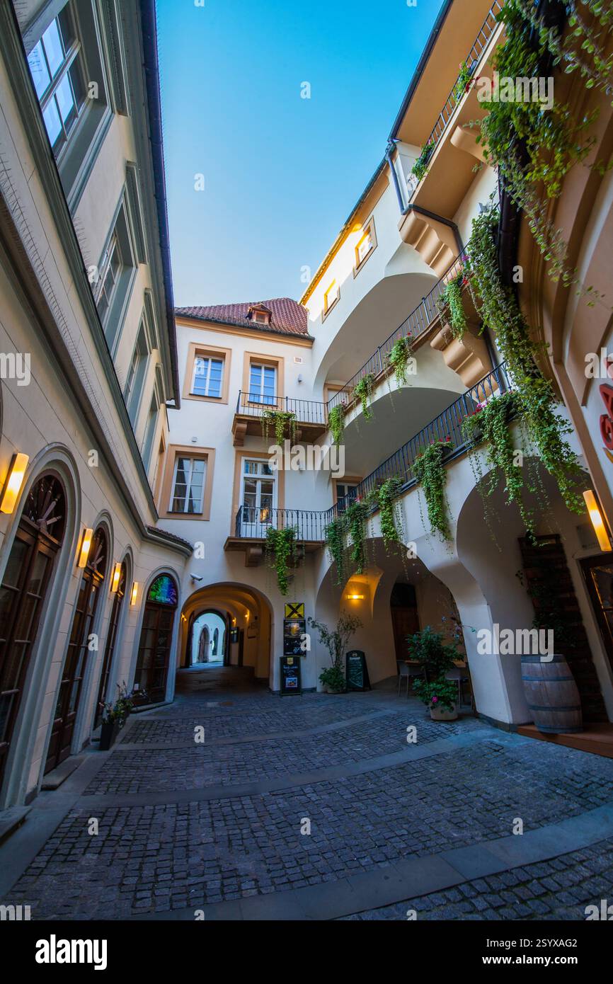 An inner courtyard with historic buildings featuring arched walkways ...