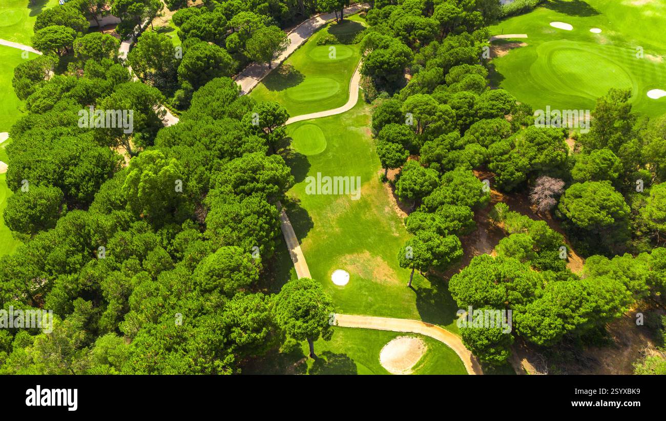 Aerial view of a golf course with putting greens, sand bunkers, and ...