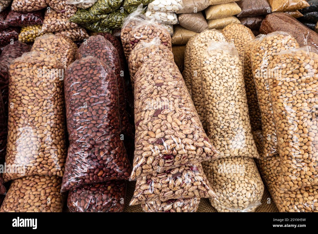 Various types of beans packaged and sold at a traditional street market ...
