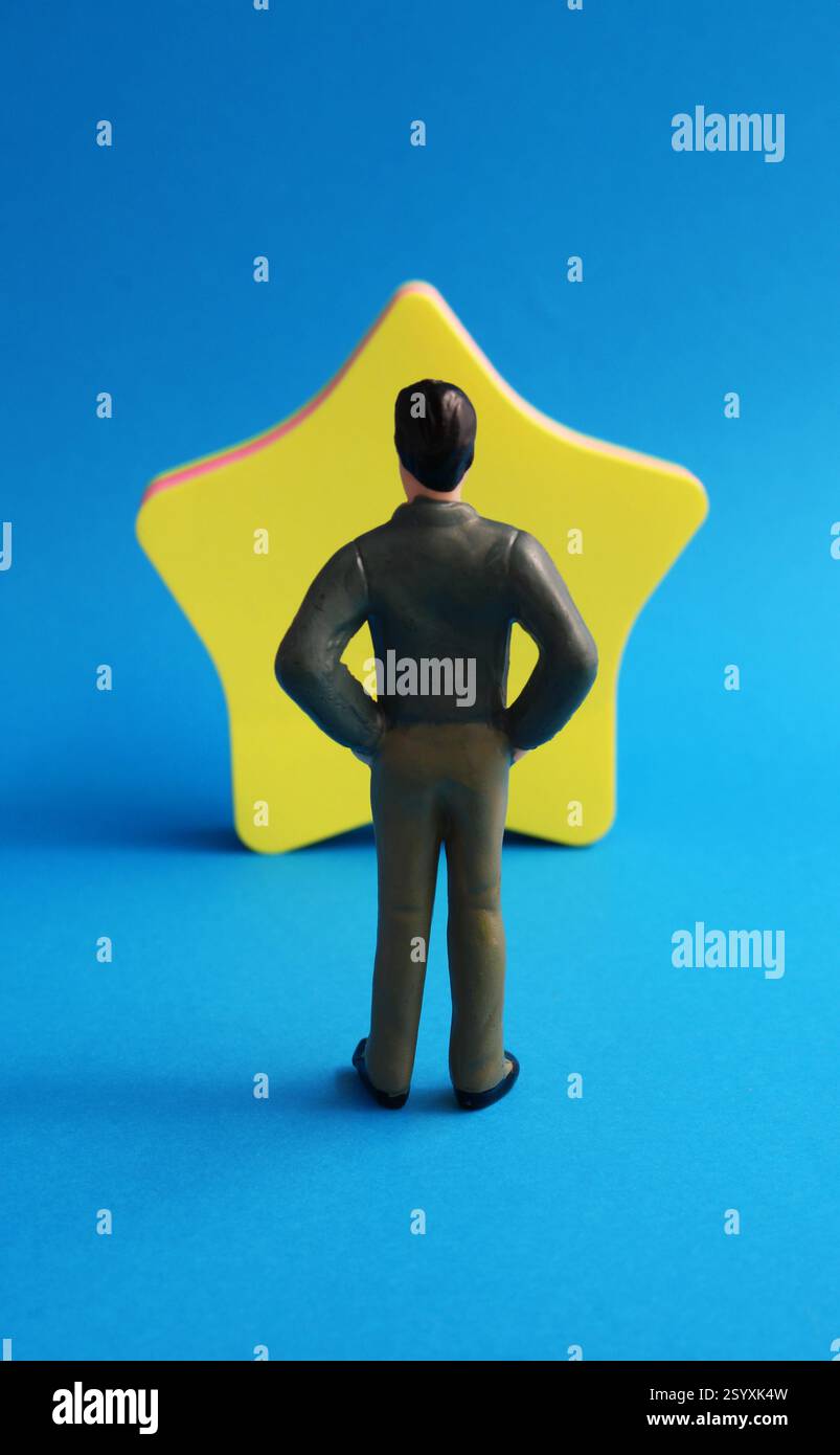 Executive in front of a successful star - vertical format Stock Photo ...