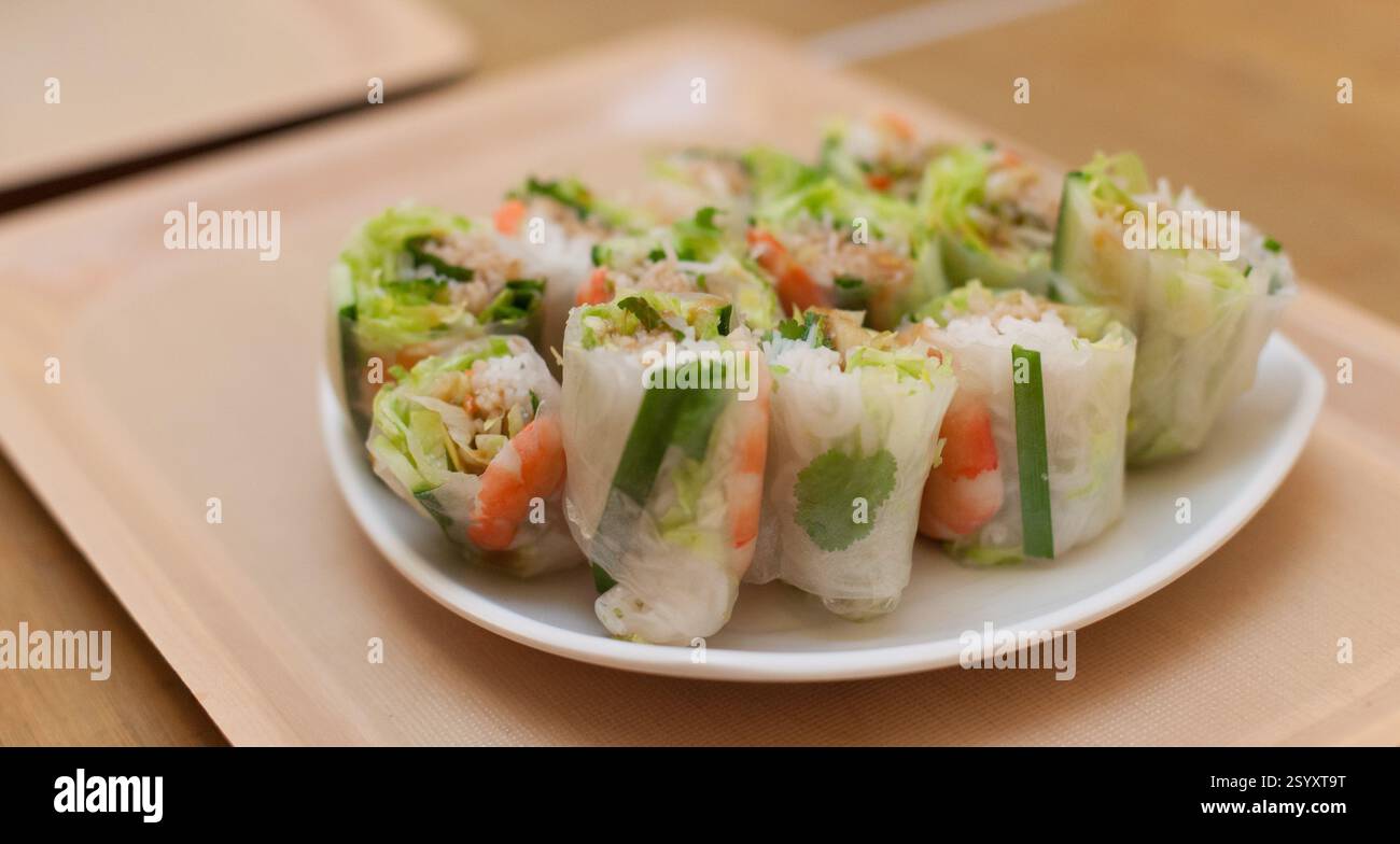 Fresh spring rolls with shrimp, rice, and vegetables on a plate. Likely ...