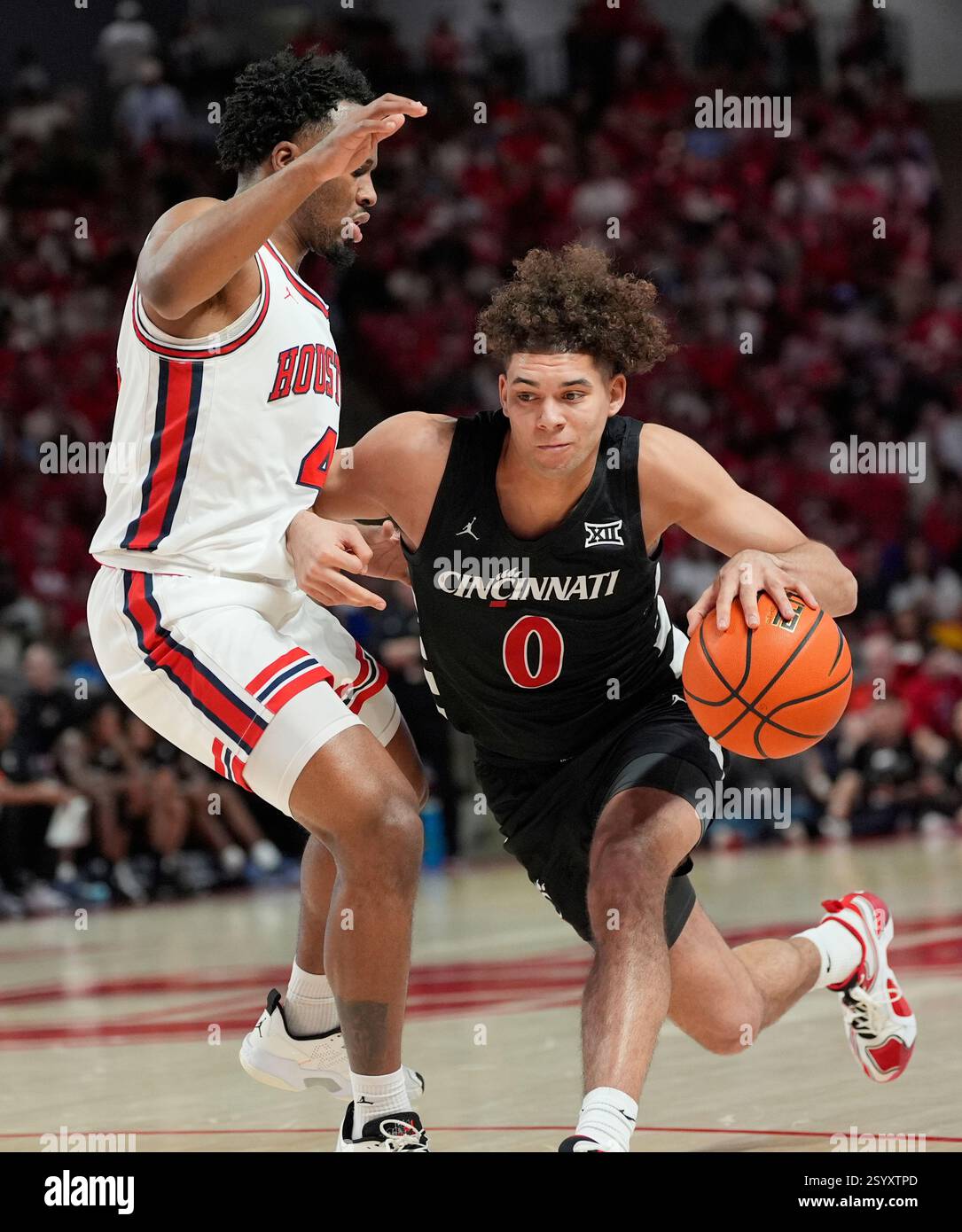 Cincinnati's Dan Skillings Jr. (0) drives toward the basket as Houston ...