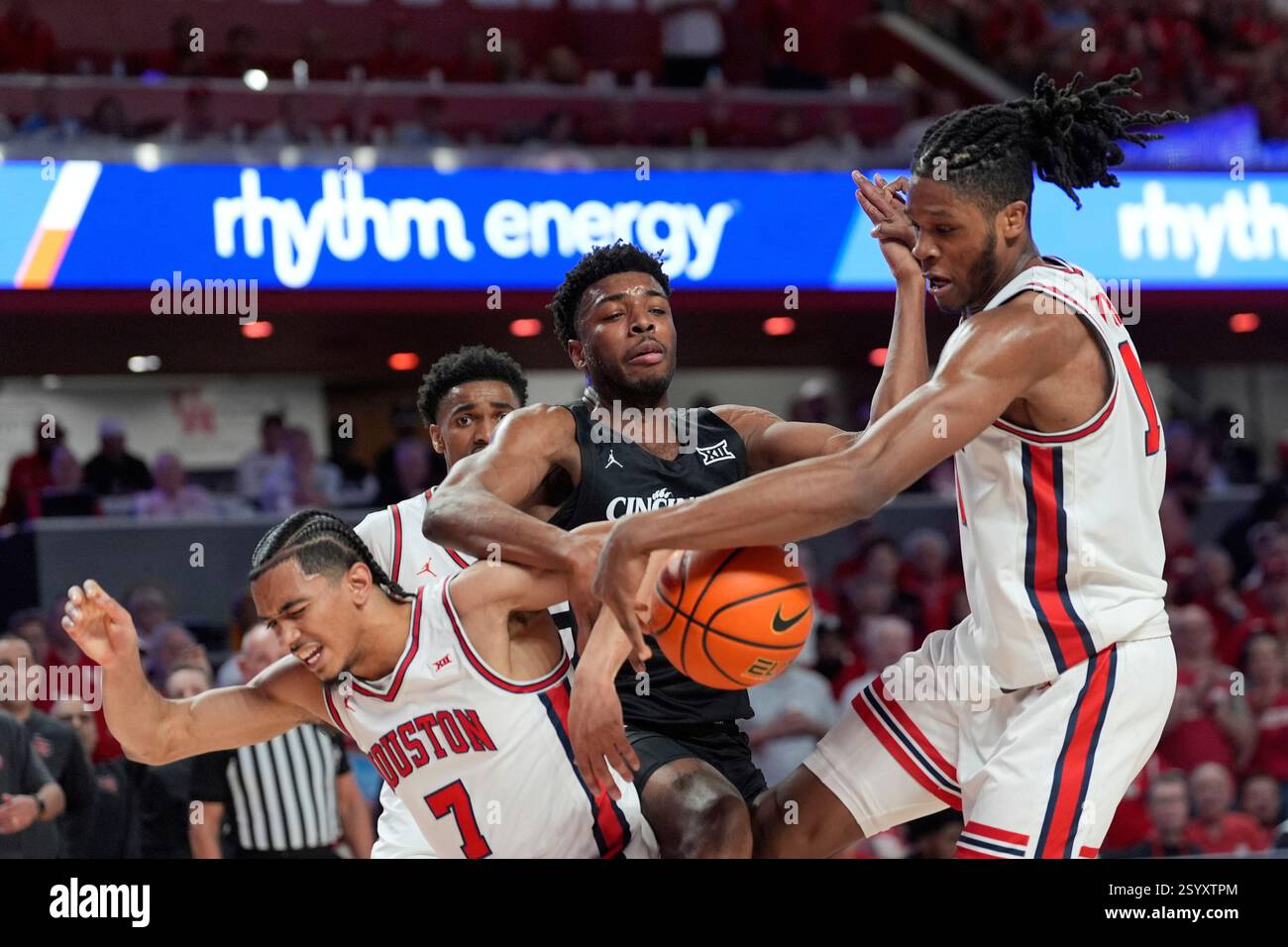 Cincinnati's Josh Reed, center, reaches for a rebound along with ...
