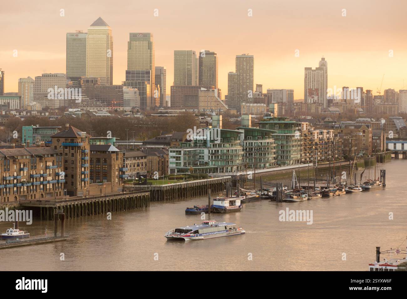 London's Canary Wharf skyline at sunset, viewed from the River Thames ...