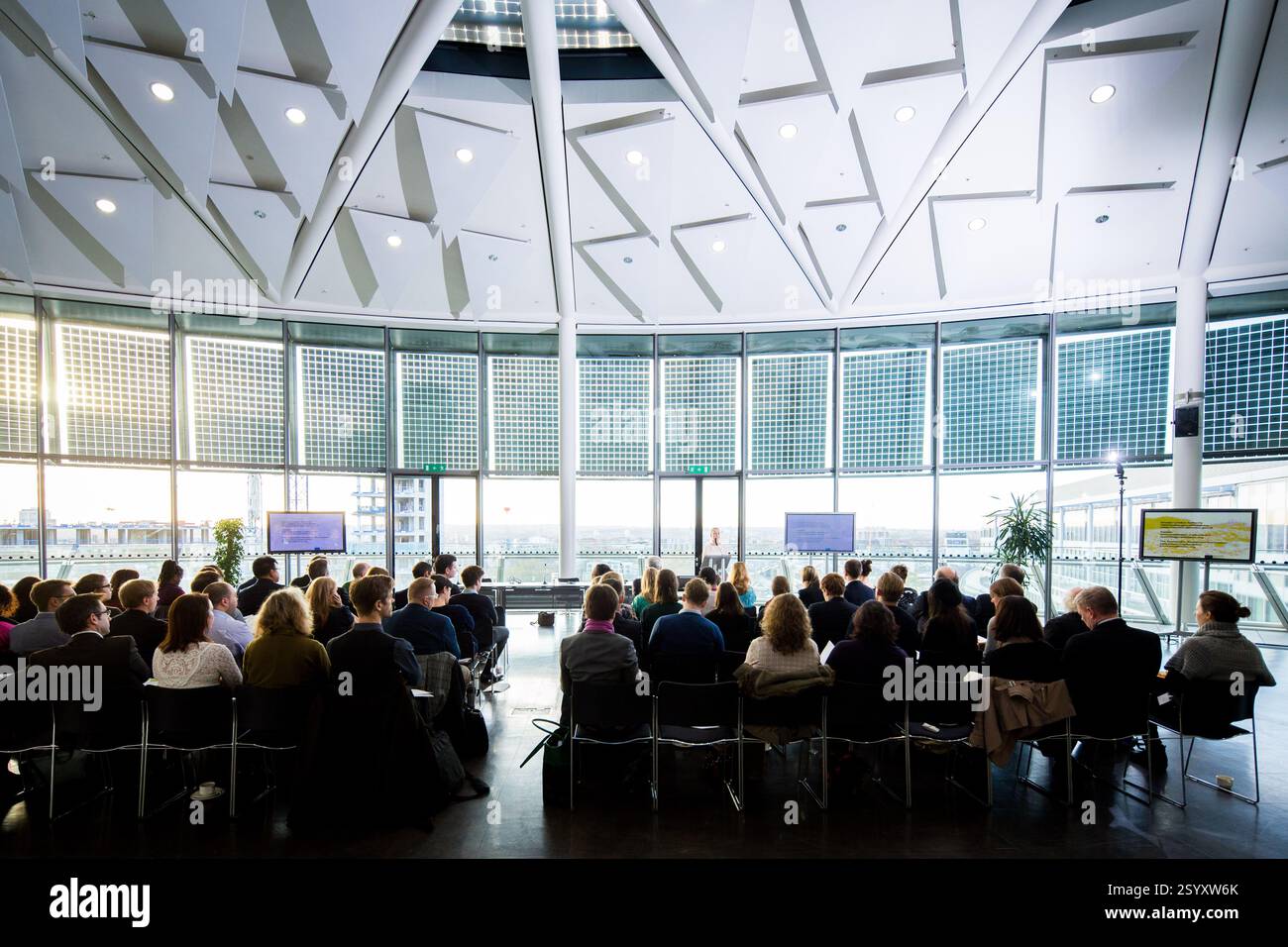 Conference attendees listen to a speaker at the London Assembly ...