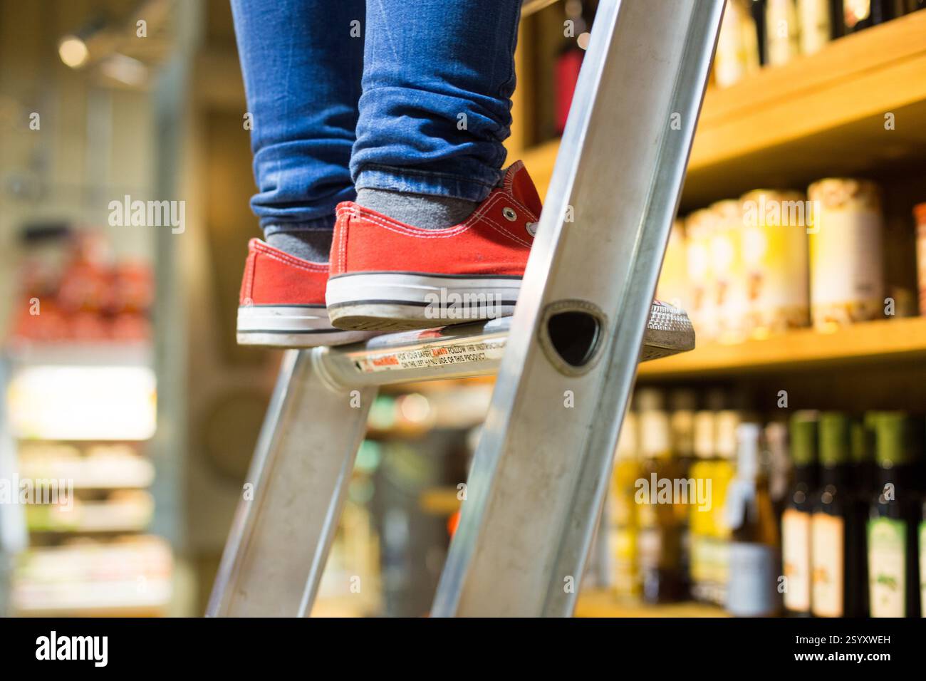 Shopkeeper stocking the shelves Stock Photo - Alamy