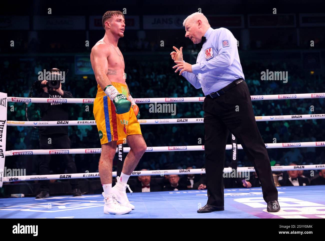 Referee Marcus McDonnell (right) speaks to Paddy Donovan in the welterweight bout against Lewis ...