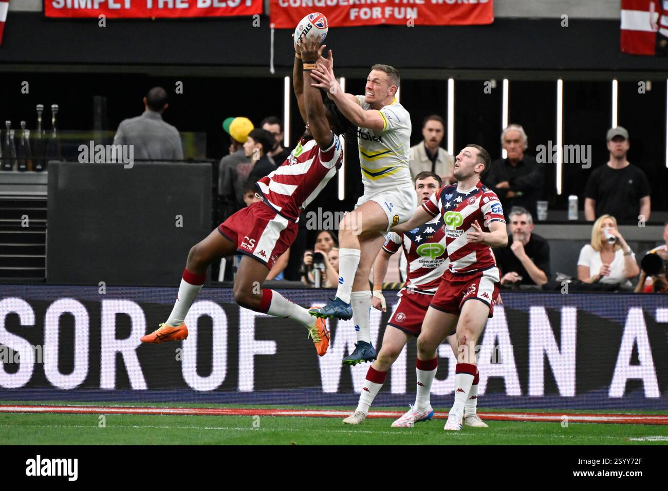 Wigan Warriors Junior Nsemba, left, reaches for the ball during the ...