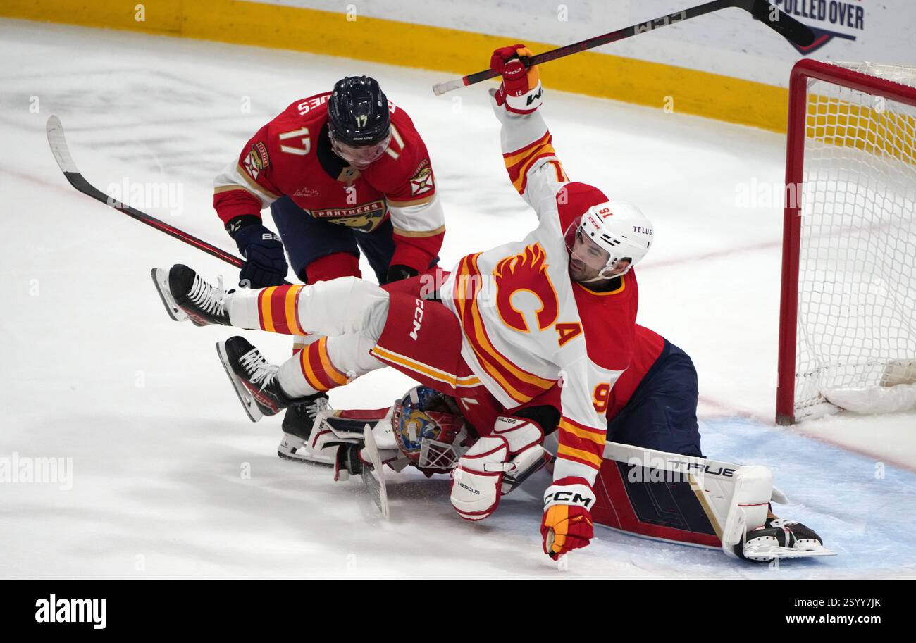 Calgary Flames center Nazem Kadri, center, falls to the ice during the ...