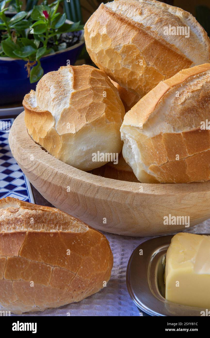 Basket of French bread, traditional Brazilian bread, with butter for ...
