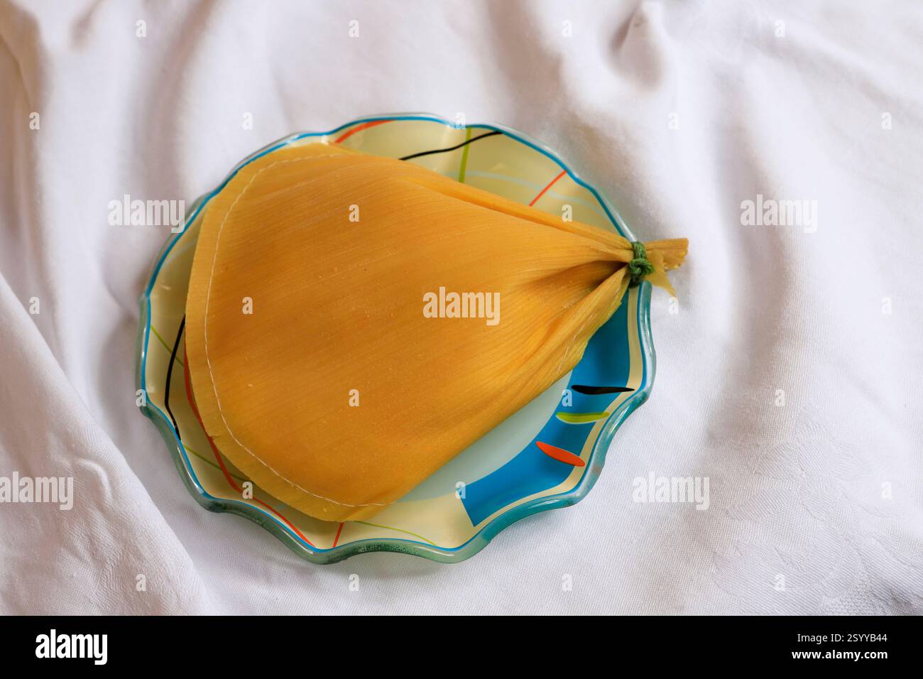 Pamonha, Brazilian sweet corn with cheese filling on white tablecloth ...