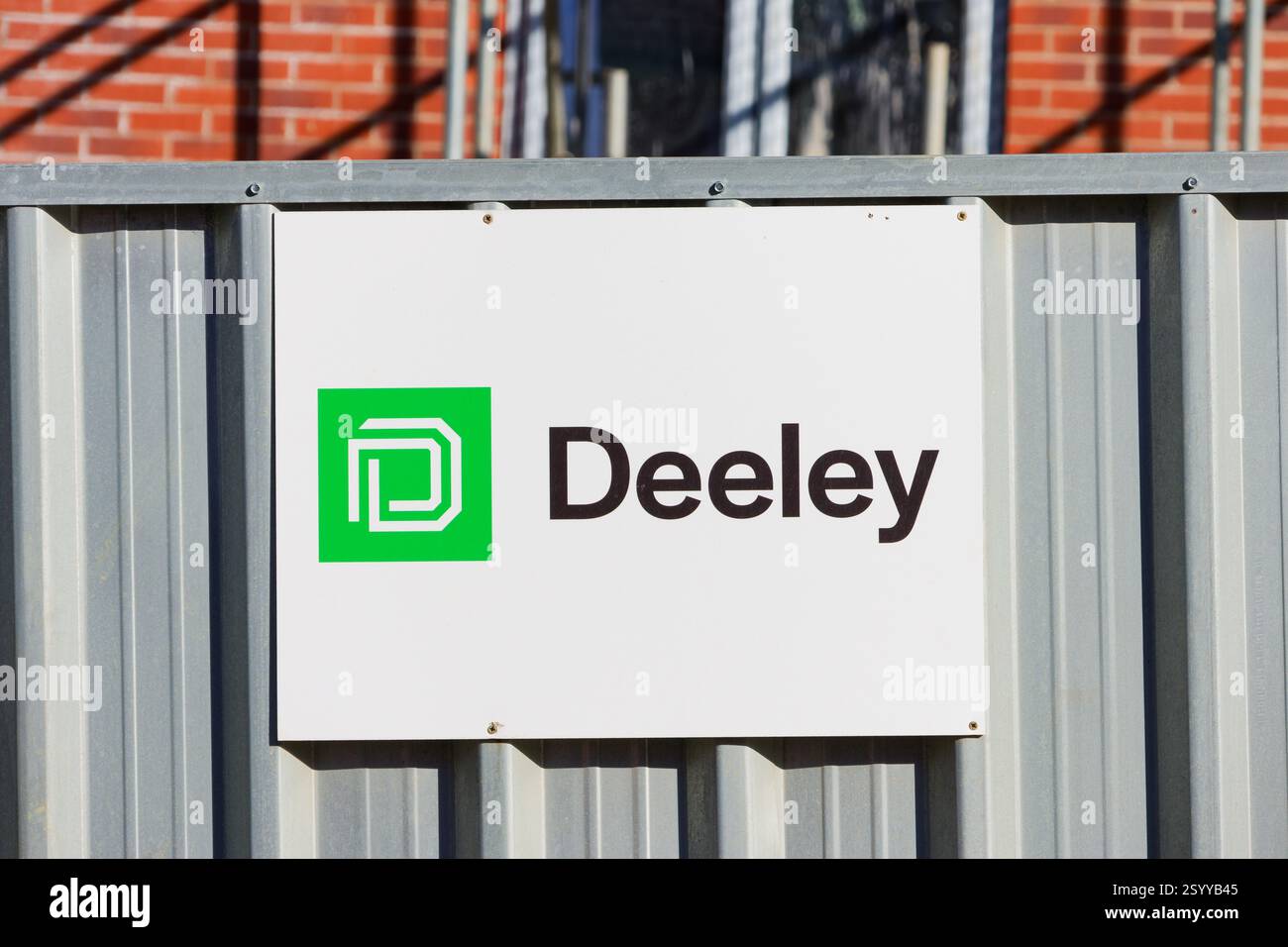 Deeley Group logo signage on corrugated construction fencing with scaffolded building behind in ...