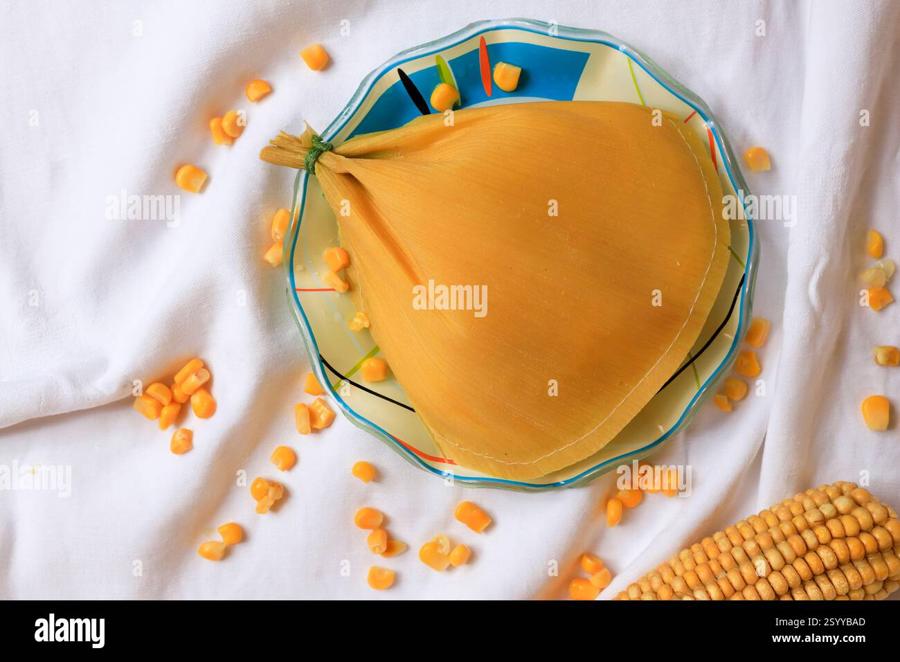 Pamonha, Brazilian sweet corn with cheese filling on white tablecloth ...