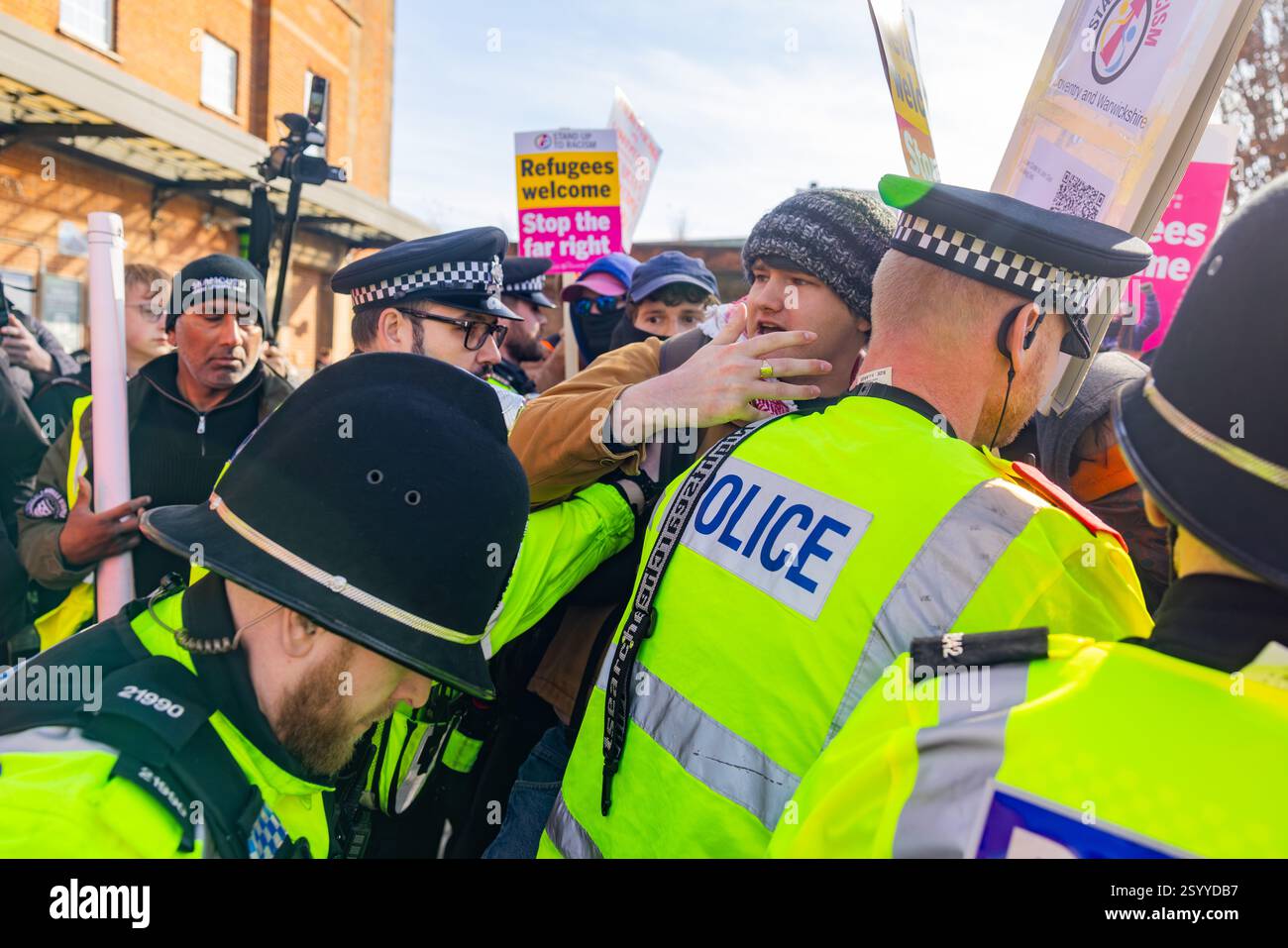 Nuneaton, UK. 01 MAR, 2025. Police grapple with counter protestors as ...