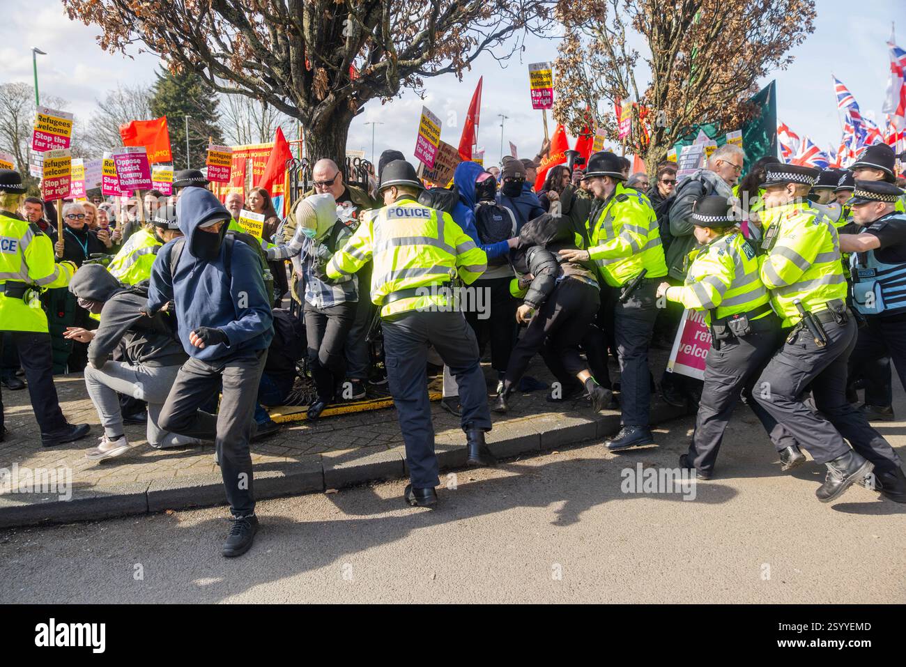 Nuneaton, UK. 01 MAR, 2025. Police clash with masked counter protestors ...