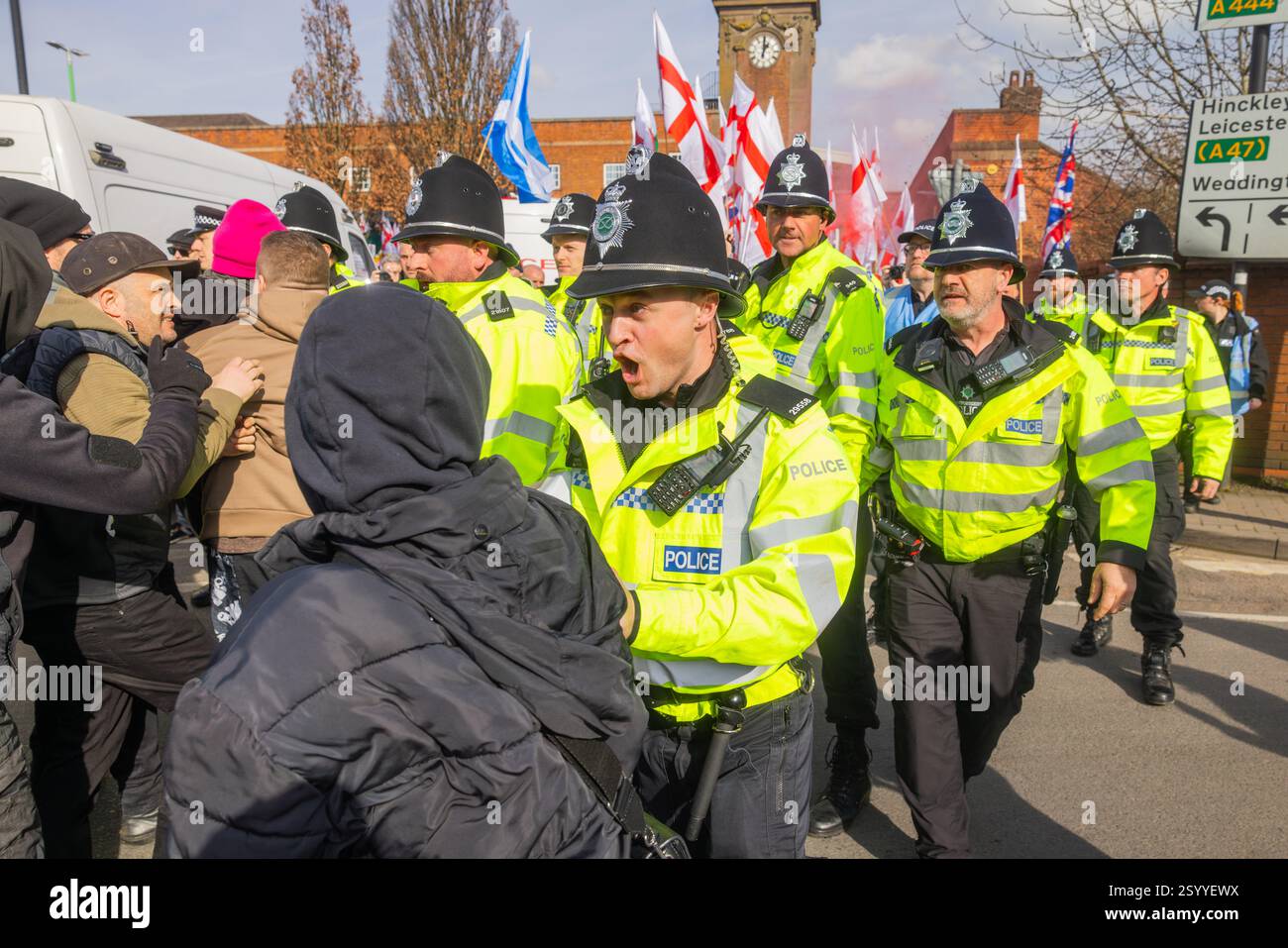 Nuneaton, UK. 01 MAR, 2025. Police clash with masked counter protestors ...