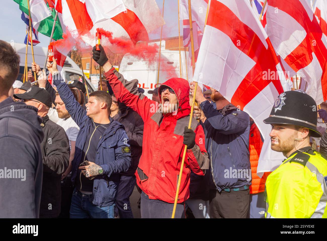 Nuneaton, UK. 01 MAR, 2025. Man with lit red flare as Britain First ...