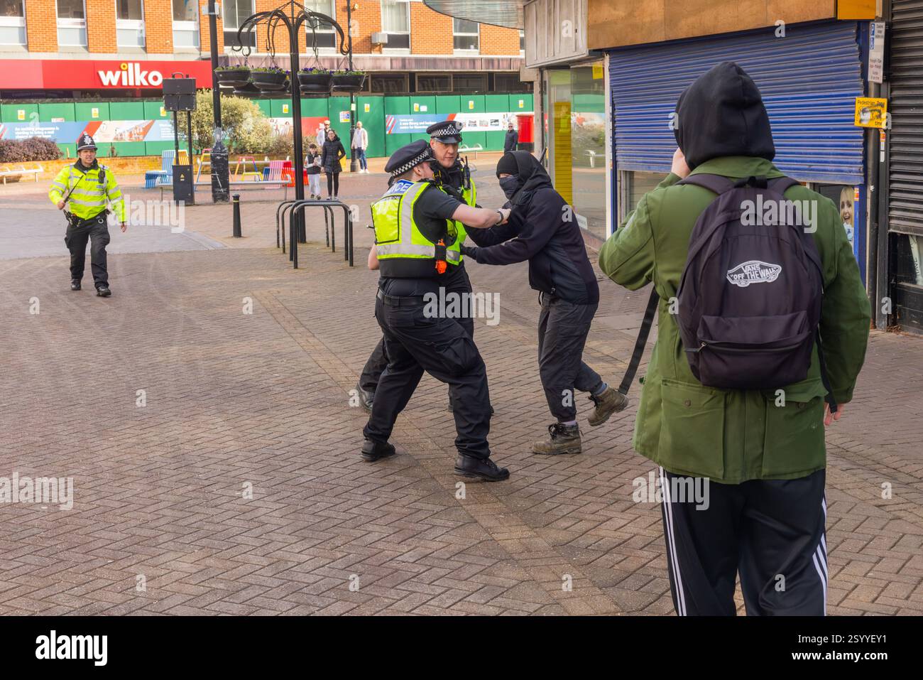 Nuneaton, UK. 01 MAR, 2025. Police with batons grapple with masked ...