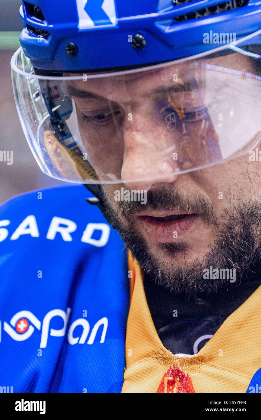 Jan Kovar #43 (EV Zug) and goalkeeper Tim Wolf #1 (EV Zug) reflected in ...