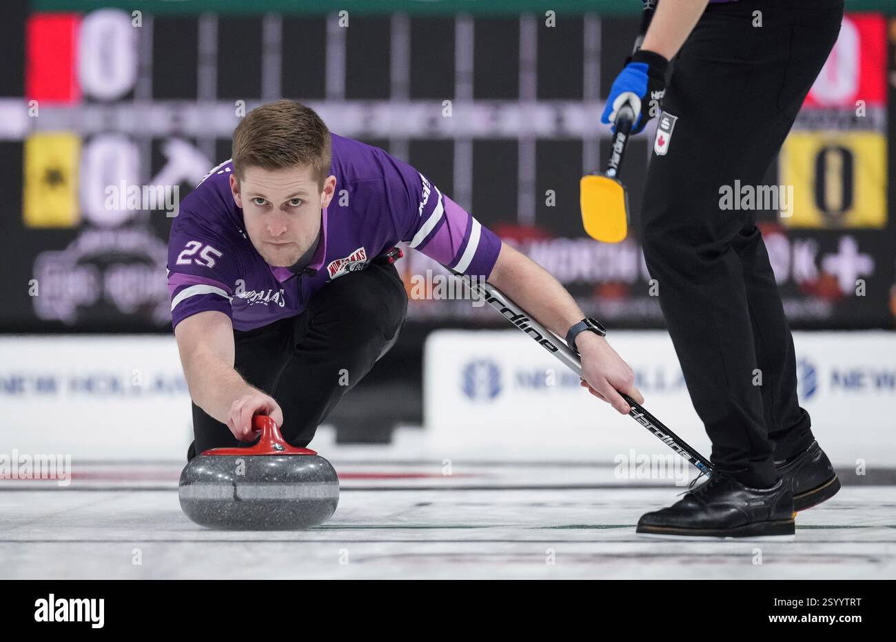 Yukon skip Thomas Scoffin delivers a rock while playing Alberta-Jacobs ...