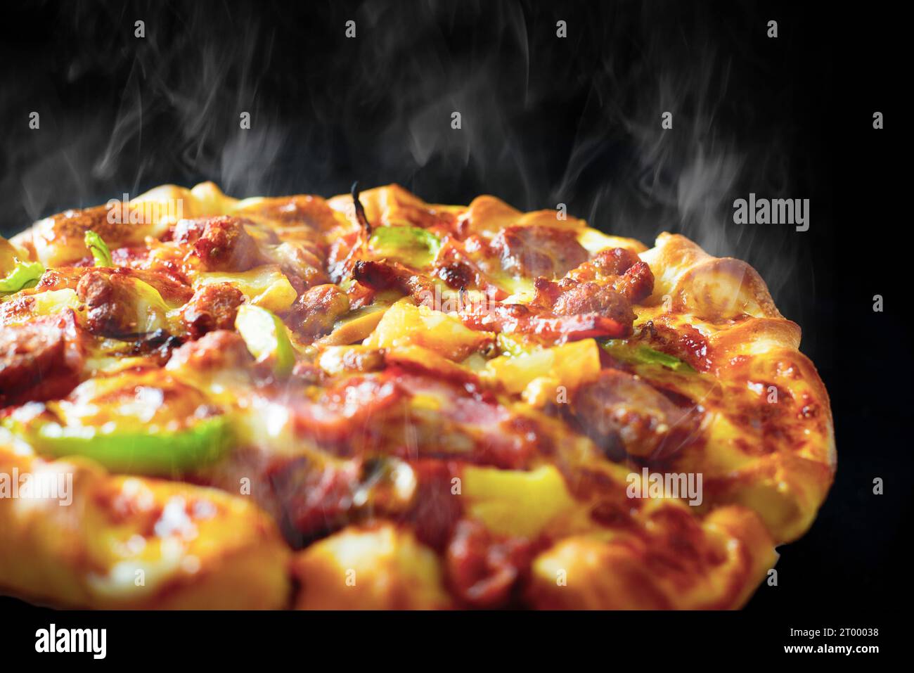 Pizza with cheese ham bacon and pepperoni on isolated black background ...