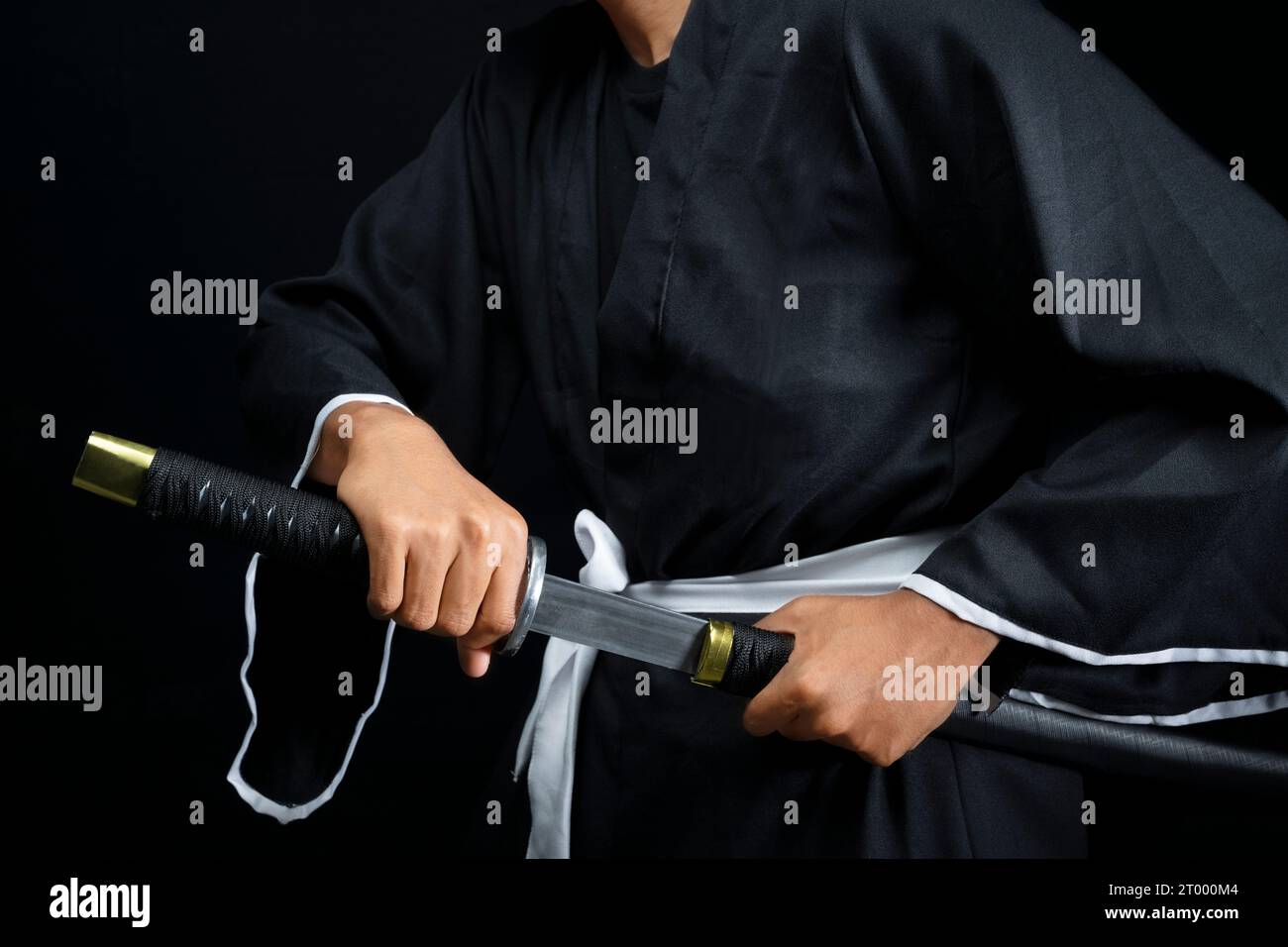 Samurai warrior gripping the sword with a black background Stock Photo ...
