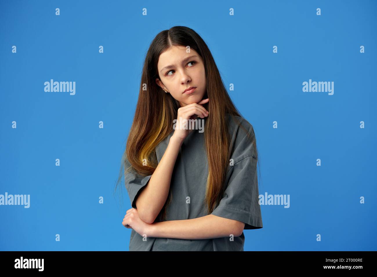 Young teen girl thinking about something over blue background Stock ...